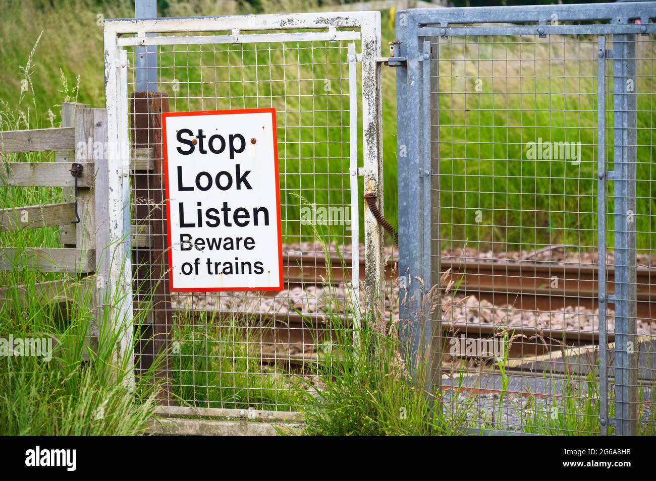 Stop look listen safety road sign at railway train station danger ...