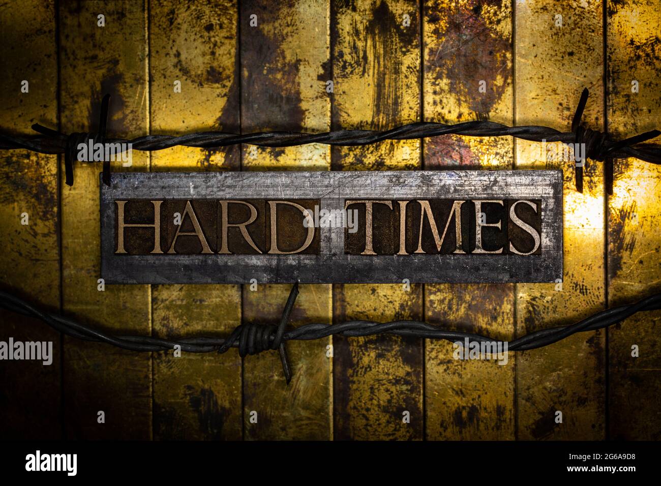 Hard Times text message lined with barbed wire on vintage textured ...