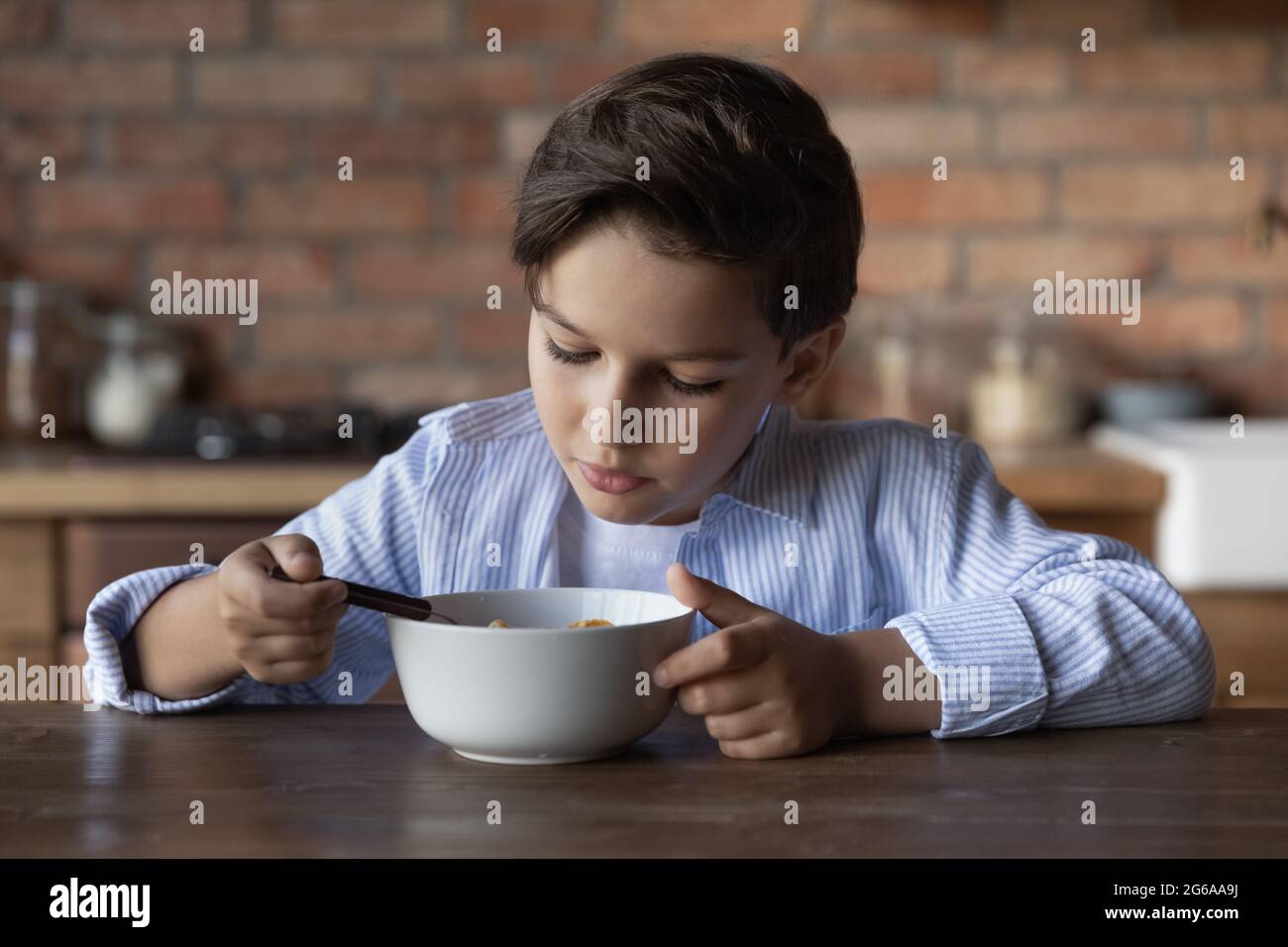 Serious focused boy kid having breakfast in kitchen Stock Photo - Alamy