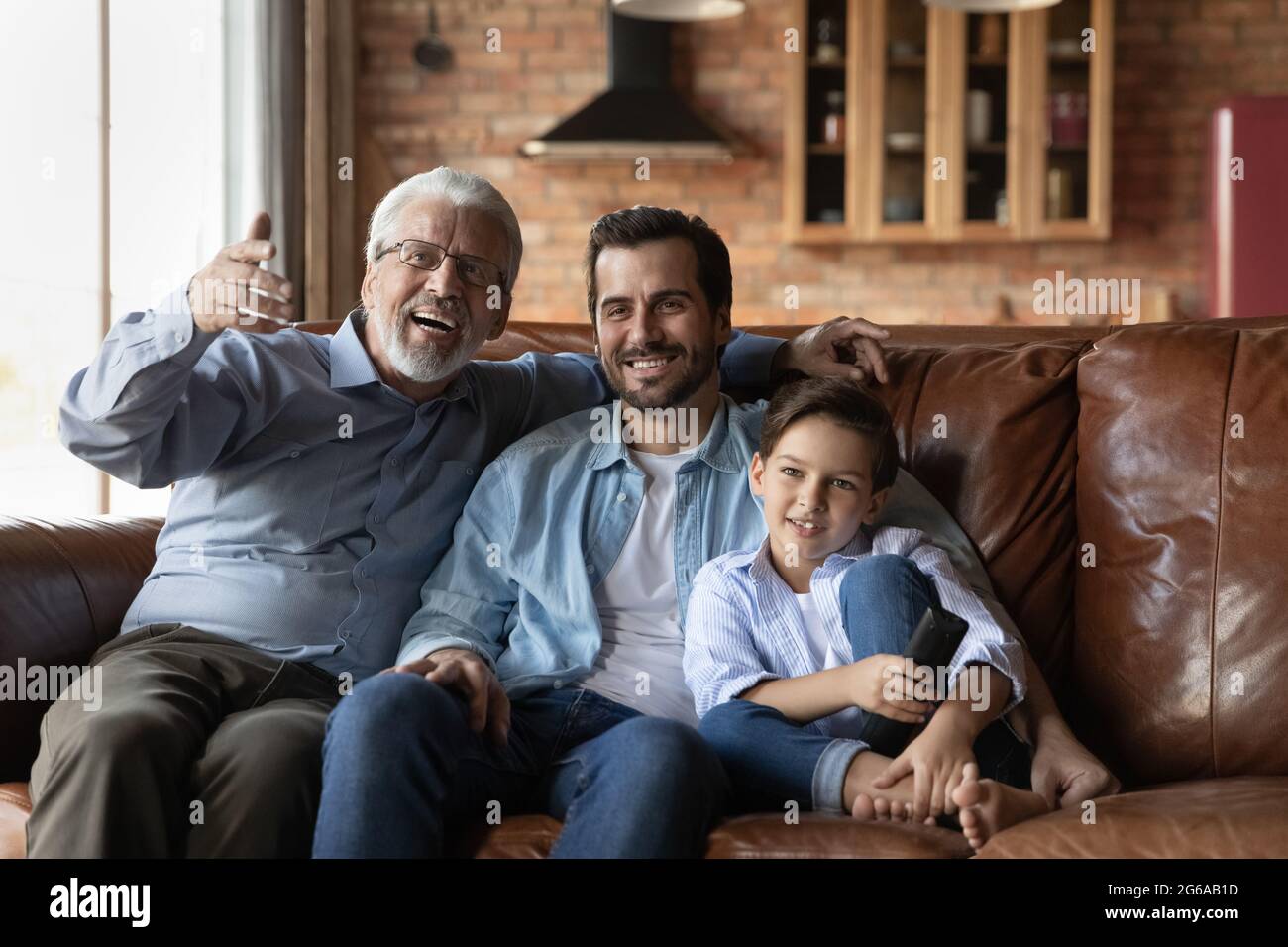 Happy preschooler boy, young dad, excited mature senior 70s grandpa ...