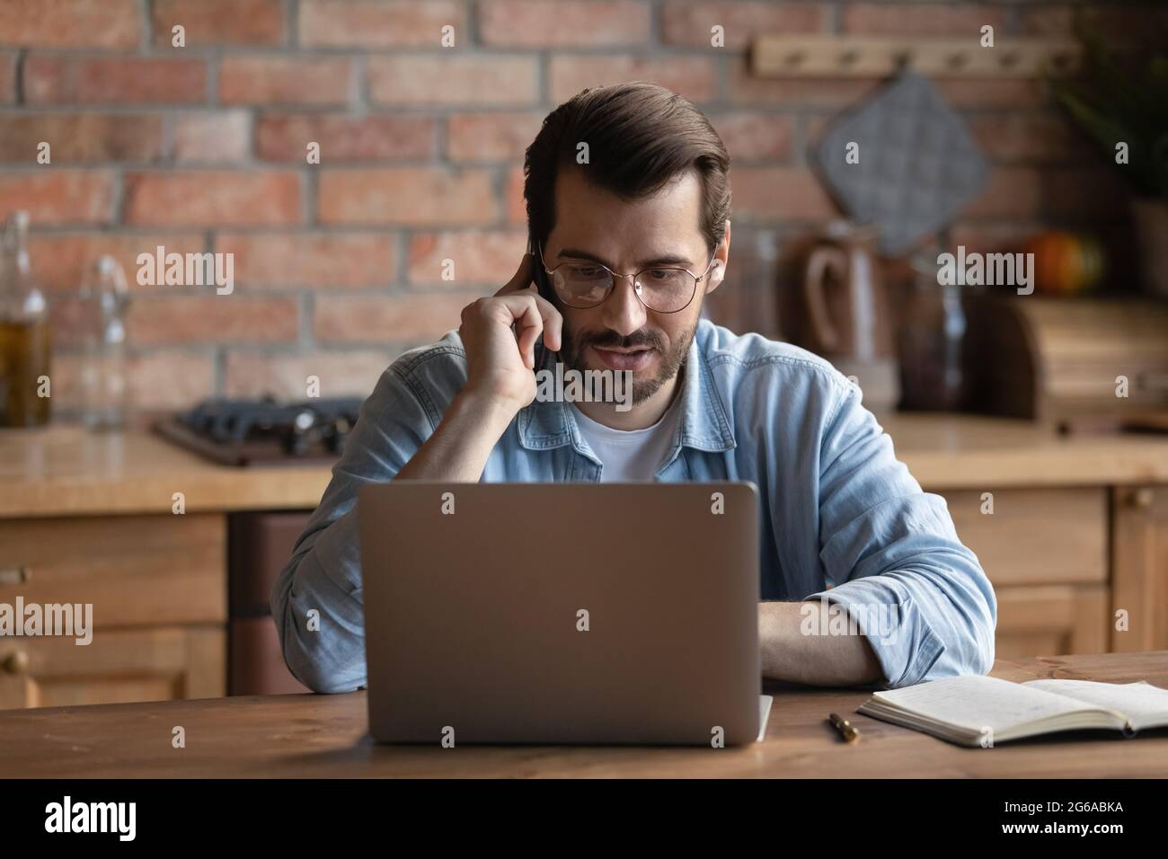 Serious millennial remote employee working at laptop from home Stock ...