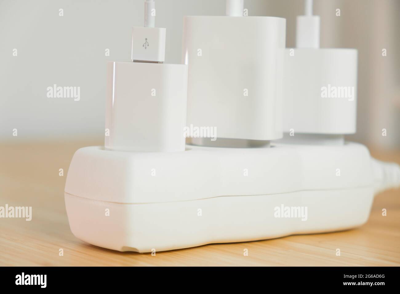 The electrical extension strip with connected white power plugs on the ...
