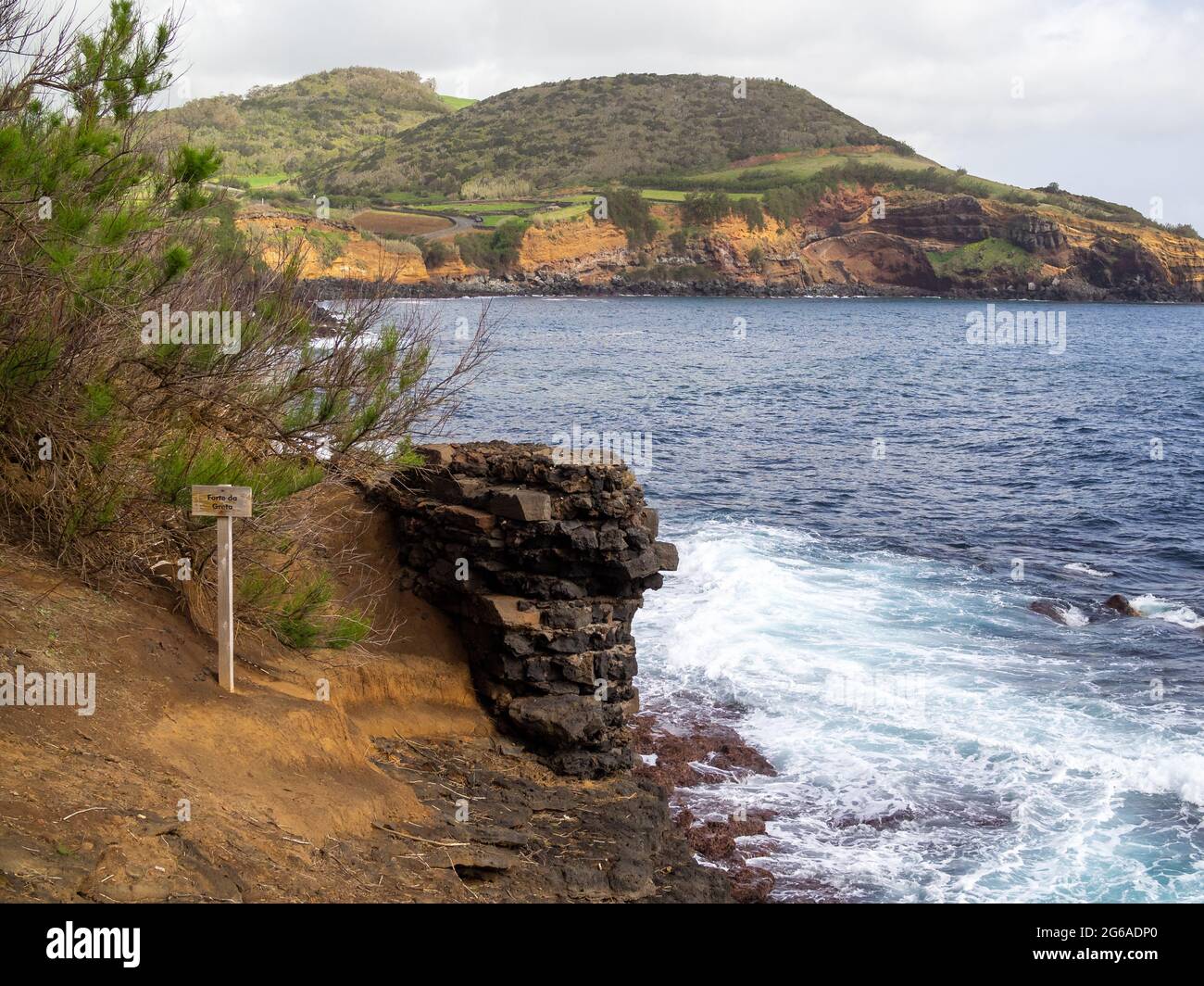 Forte da Greta ruins over the orange cliffs, Terceira Island, Azores ...