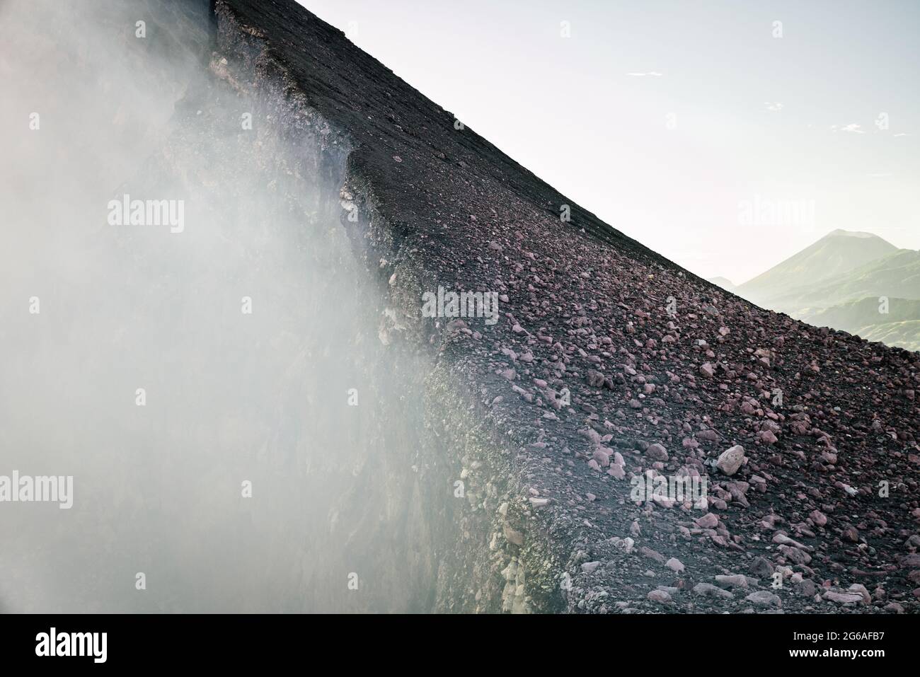 Close-up view of the edge of an active volcano, with sulfur smoke ...