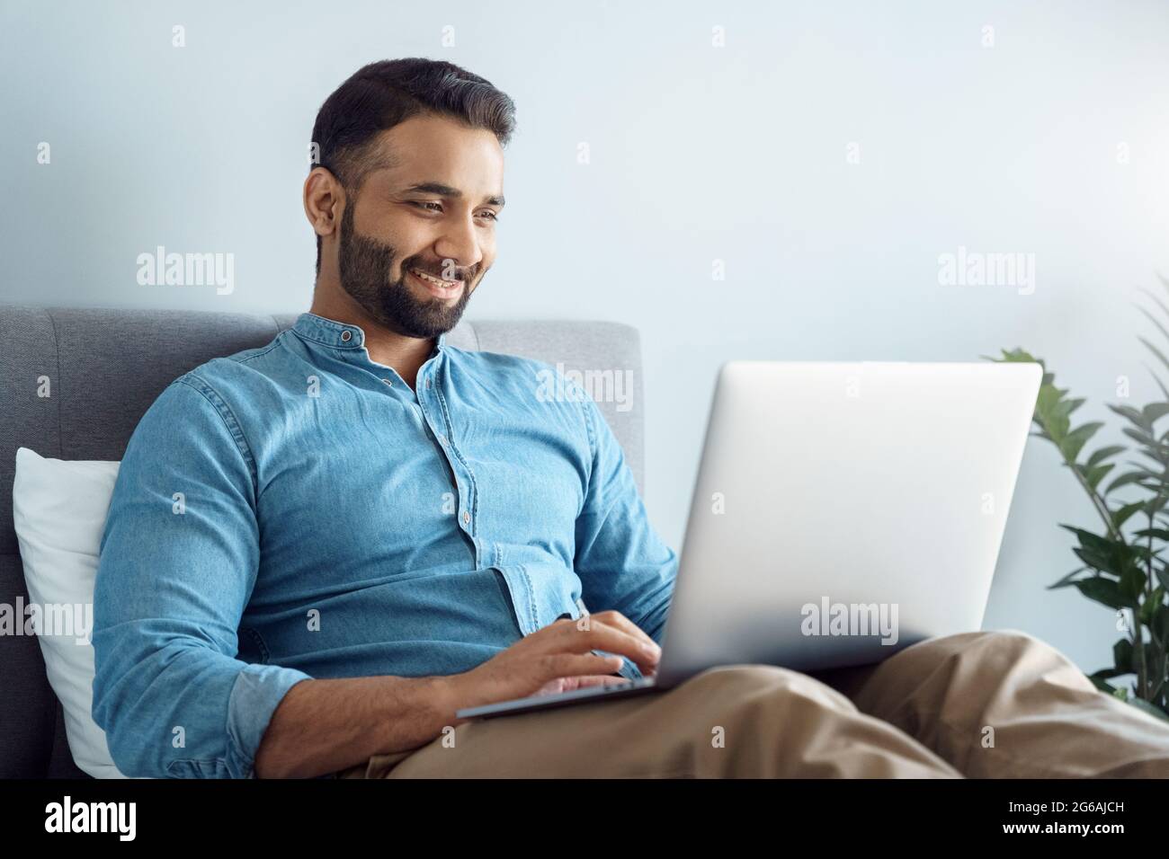 Indian man using laptop home hi-res stock photography and images - Alamy