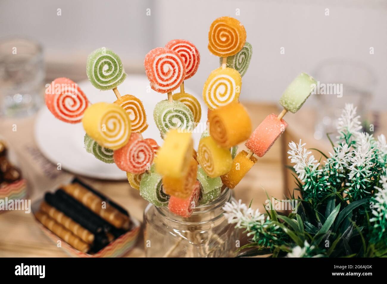 Sweet colorful fruit candies with sugar and natural juice on wooden ...