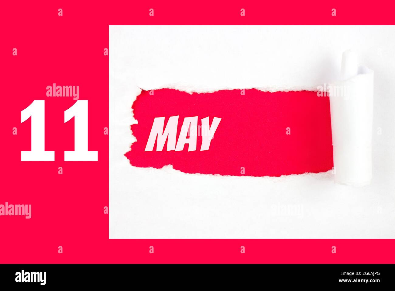 May 11st . Day 11 of month, Calendar date. Red Hole in the white paper ...
