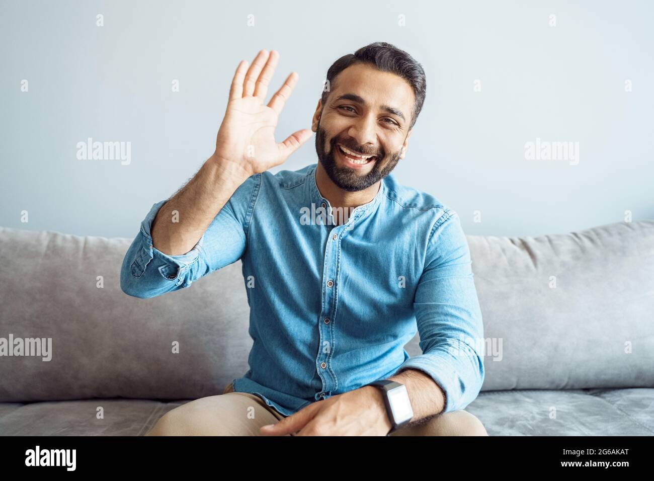 Headshot portrait of handsome indian man with friendly smile waving to ...