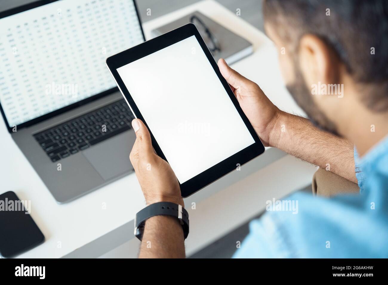 Closeup over shoulder view on mobile tablet pc blank screen in male ...