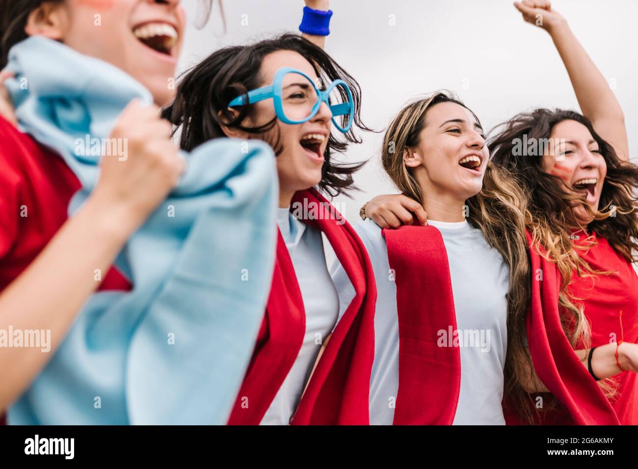 Excited multi generational women football fans supporting their team at ...