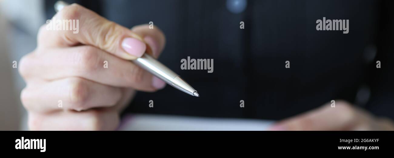 Female hand makes notes with pen in notebook Stock Photo - Alamy