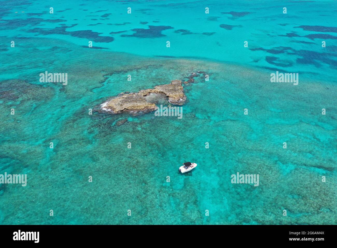 Aerial view of boats anchored near coral rocks off North Bimini ...