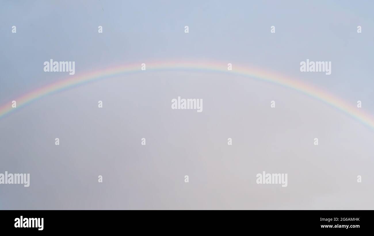 Rainbow in grey sky - nature concept Stock Photo - Alamy