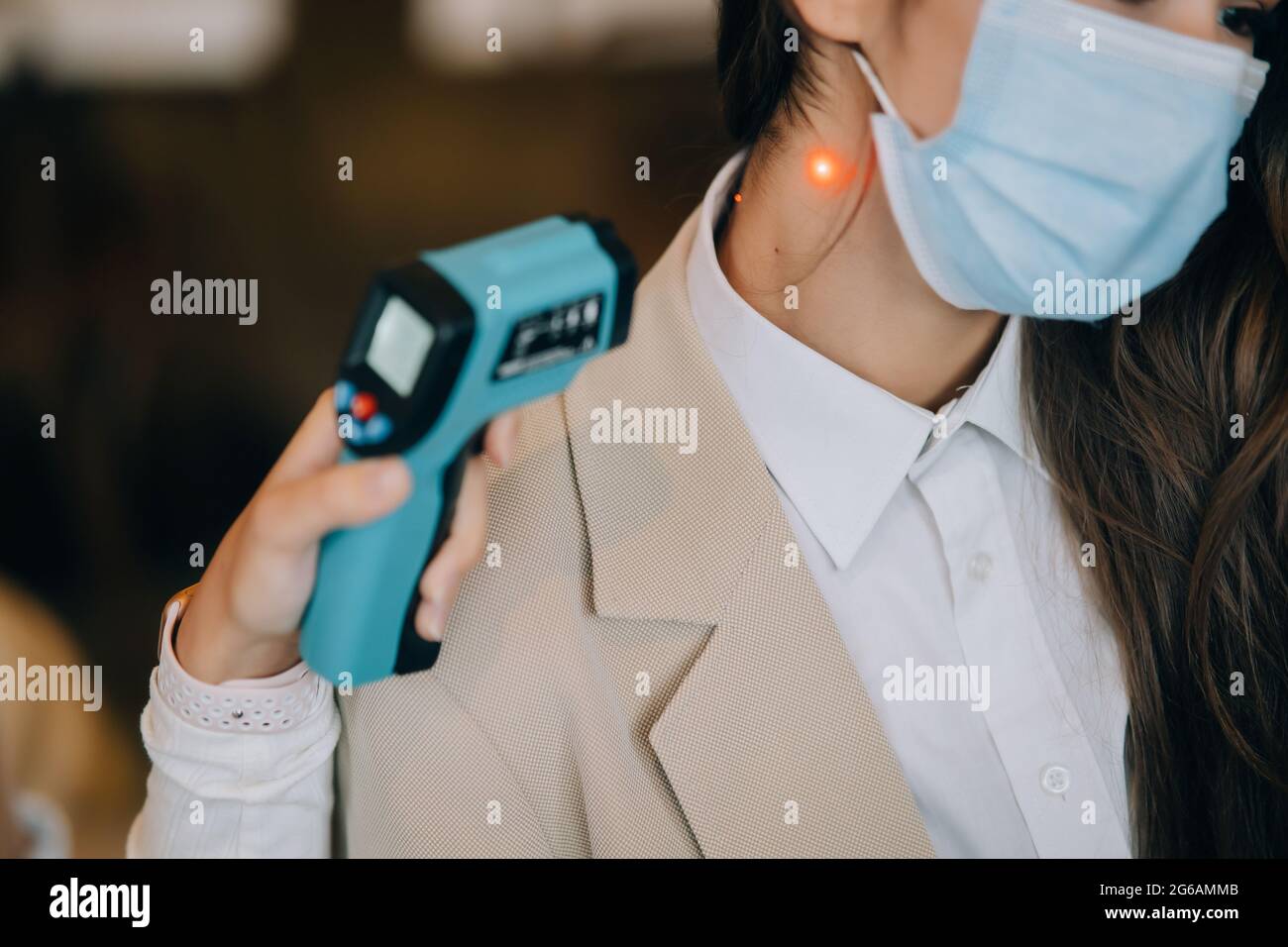 Measuring body temperature with contactless body thermometer Stock ...
