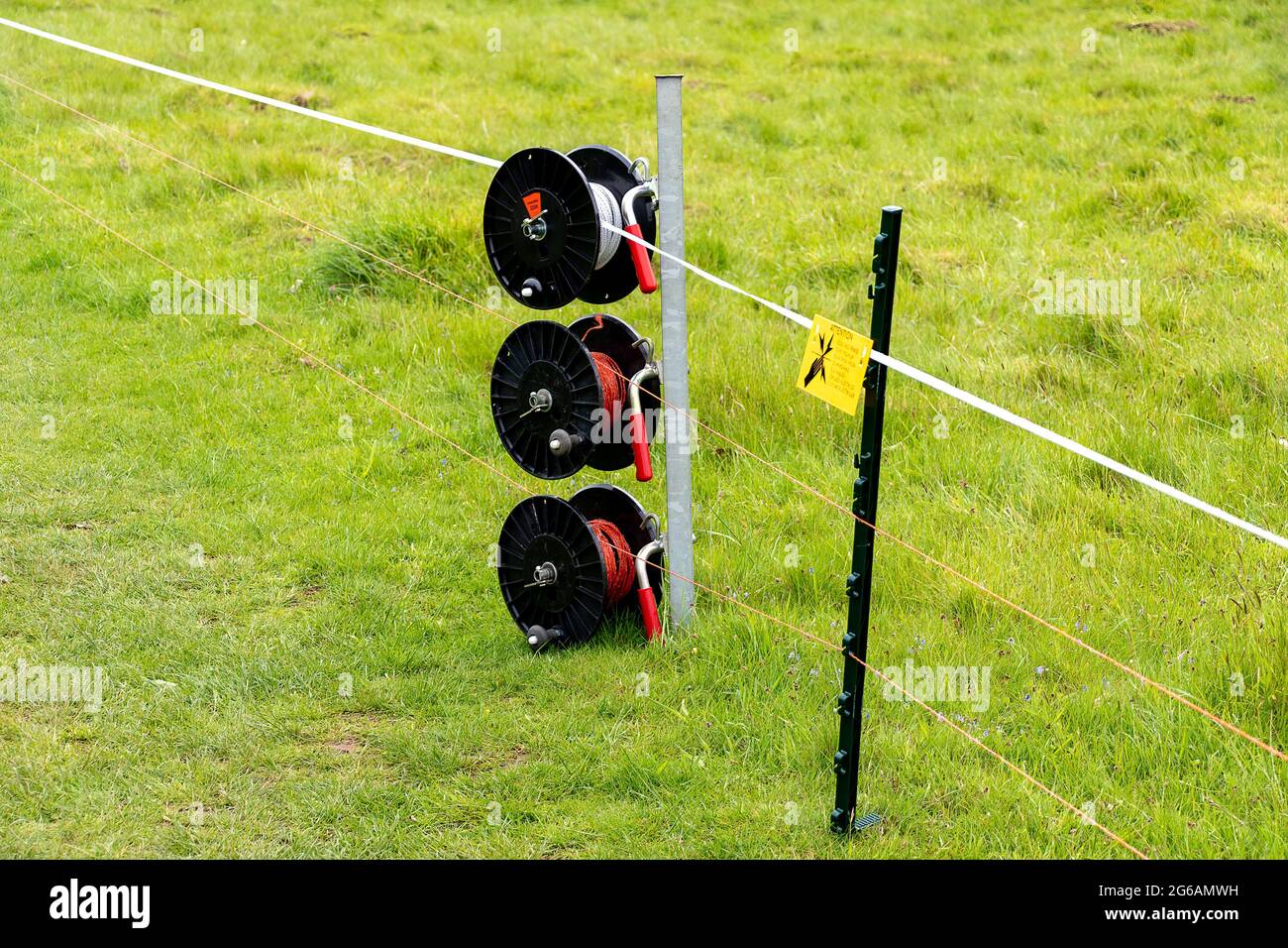 Electric fence wire on storage cog wheels to make up an electric fence ...