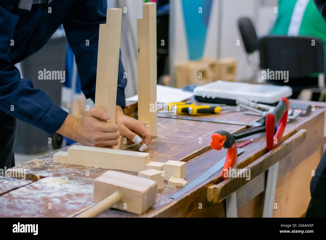 Professional man carpenter working with wooden detail - assembling ...