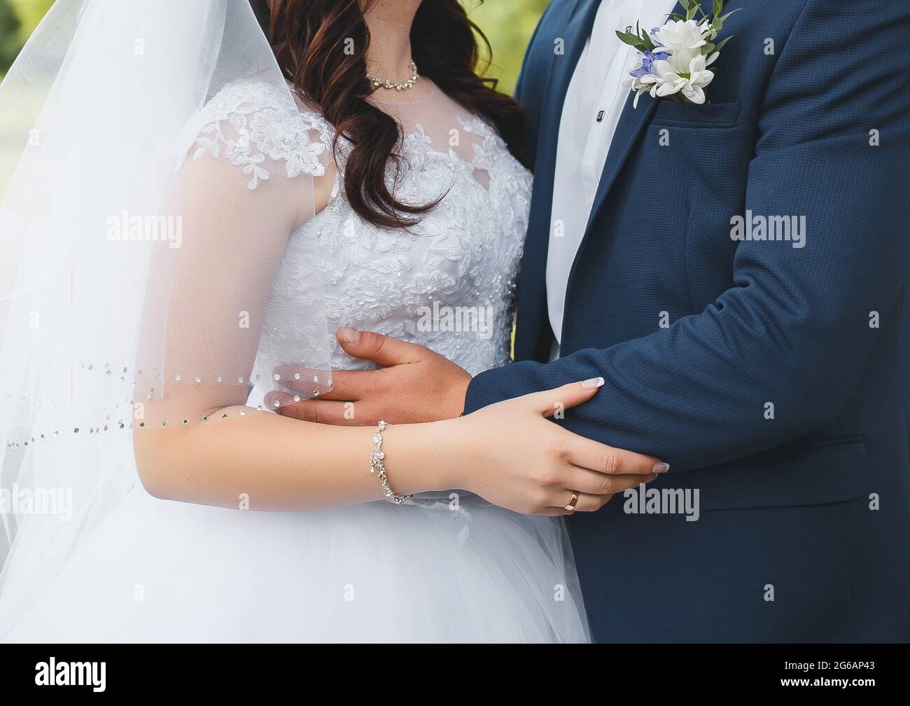 The hands of the bride and groom hug each other. Tenderness and hugs of ...