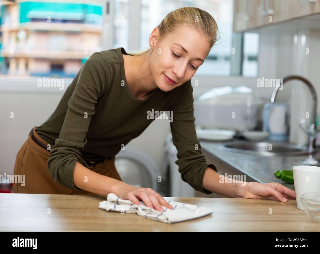 Female is caring about clean of kitchen at her house Stock Photo - Alamy