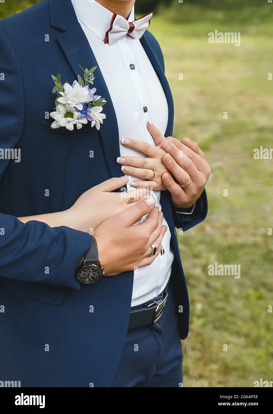 The hands of the bride and groom hug each other. Tenderness and hugs of ...