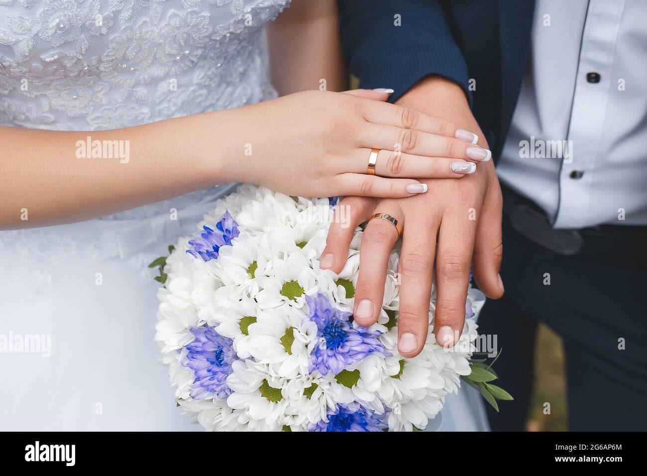 Tenderness and weasel hands of the bride and groom on the wedding ...