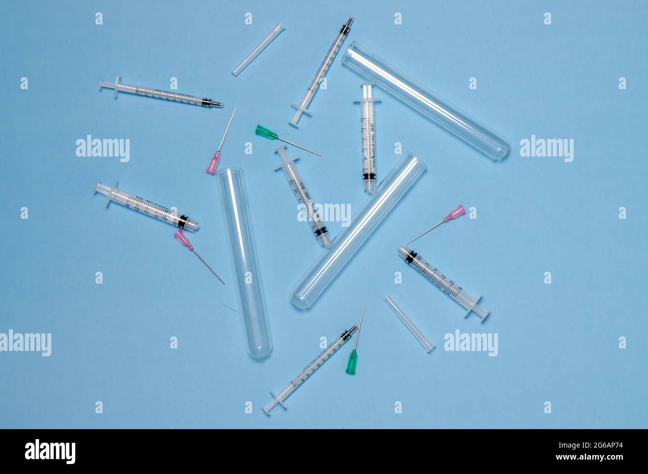 Vaccine concept. Syringes, test tube and needles on blue background ...