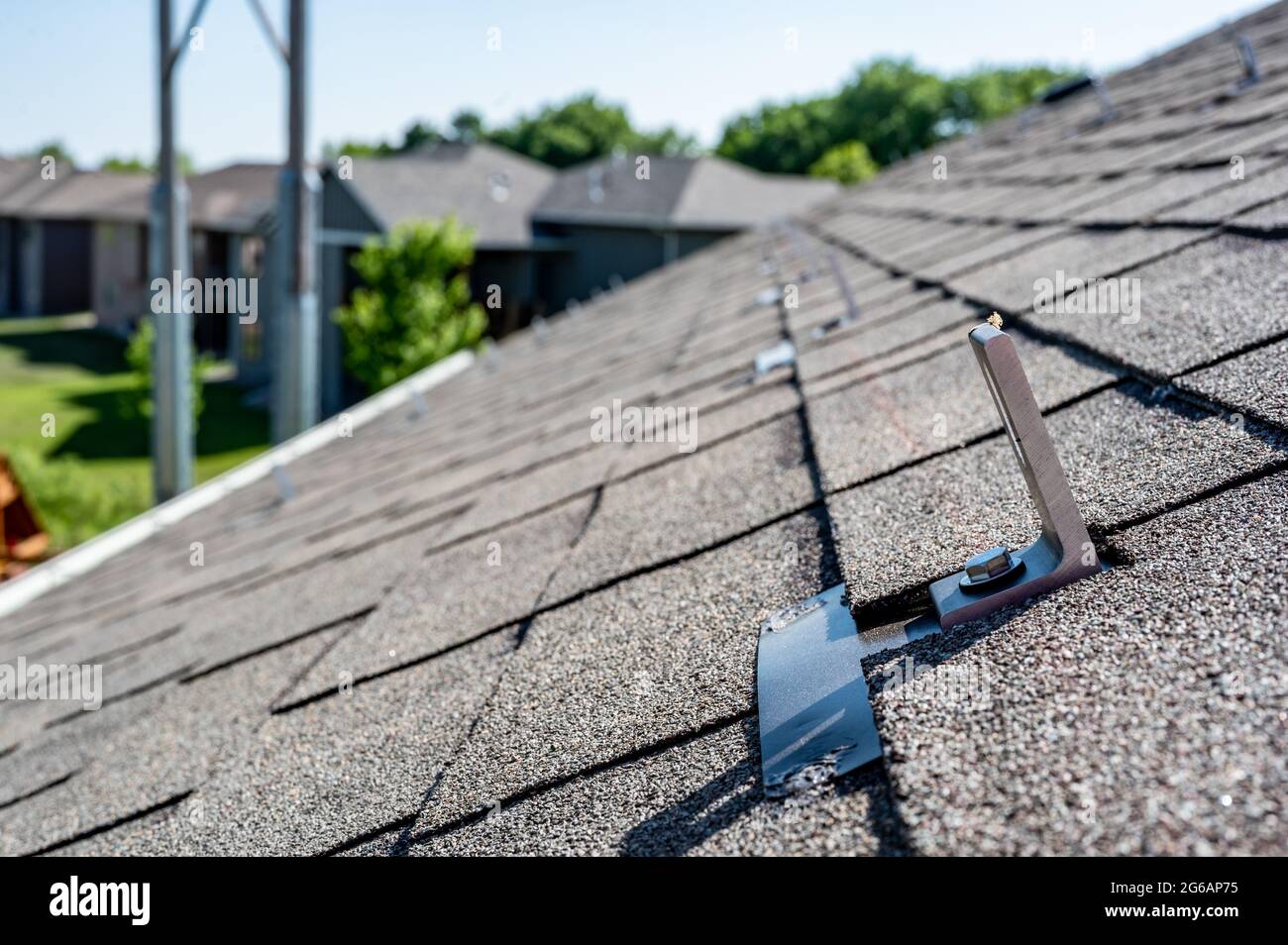 Residential asphalt shingle roof with metal anchors installed for the ...