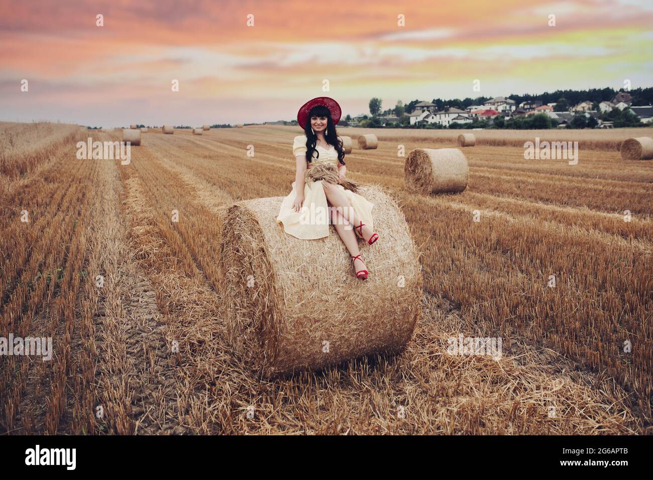 Pretty lady on the haystack Stock Photo - Alamy