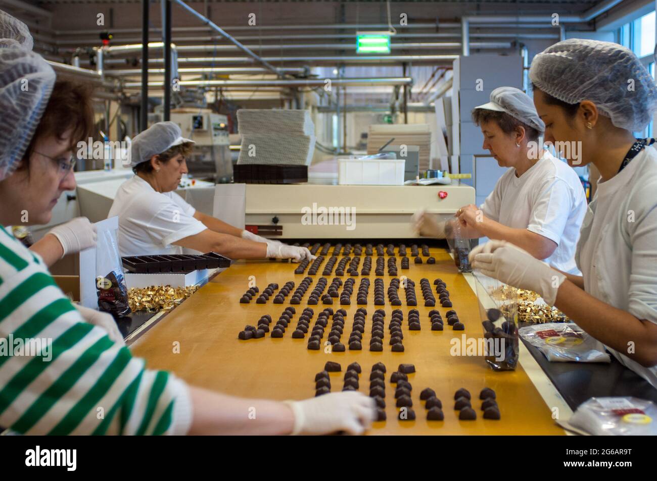 Women workers packing chocolates Stock Photo - Alamy