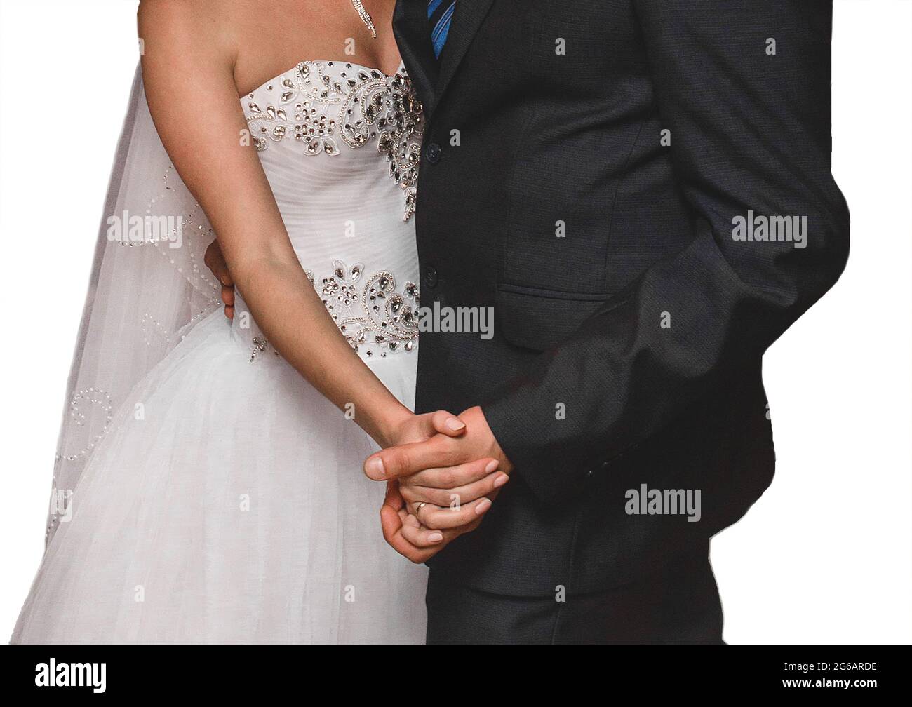 The bride and groom hold hands during a dance at the wedding on a white ...