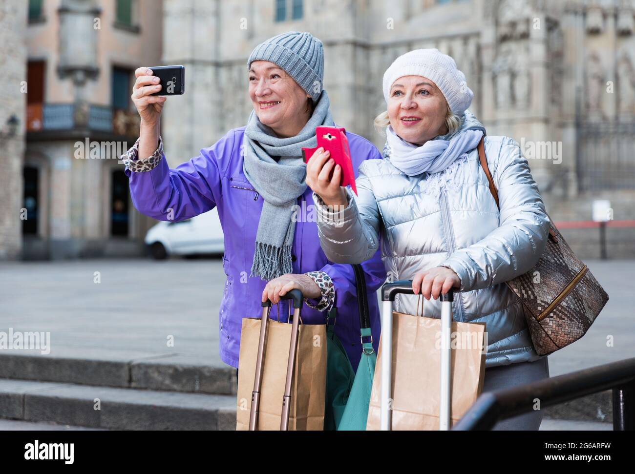 Senior women photographing city attractions Stock Photo - Alamy