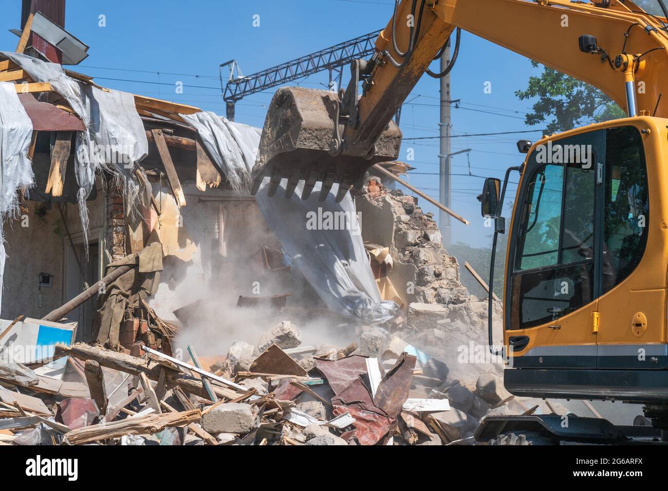 Process of demolition of old building dismantling. Excavator breaking ...