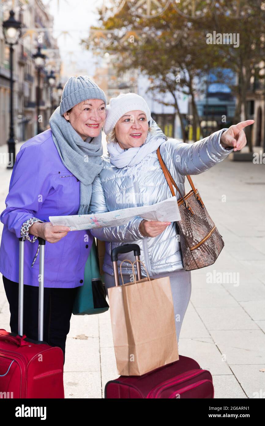 Elderly women tourists with city guide Stock Photo - Alamy