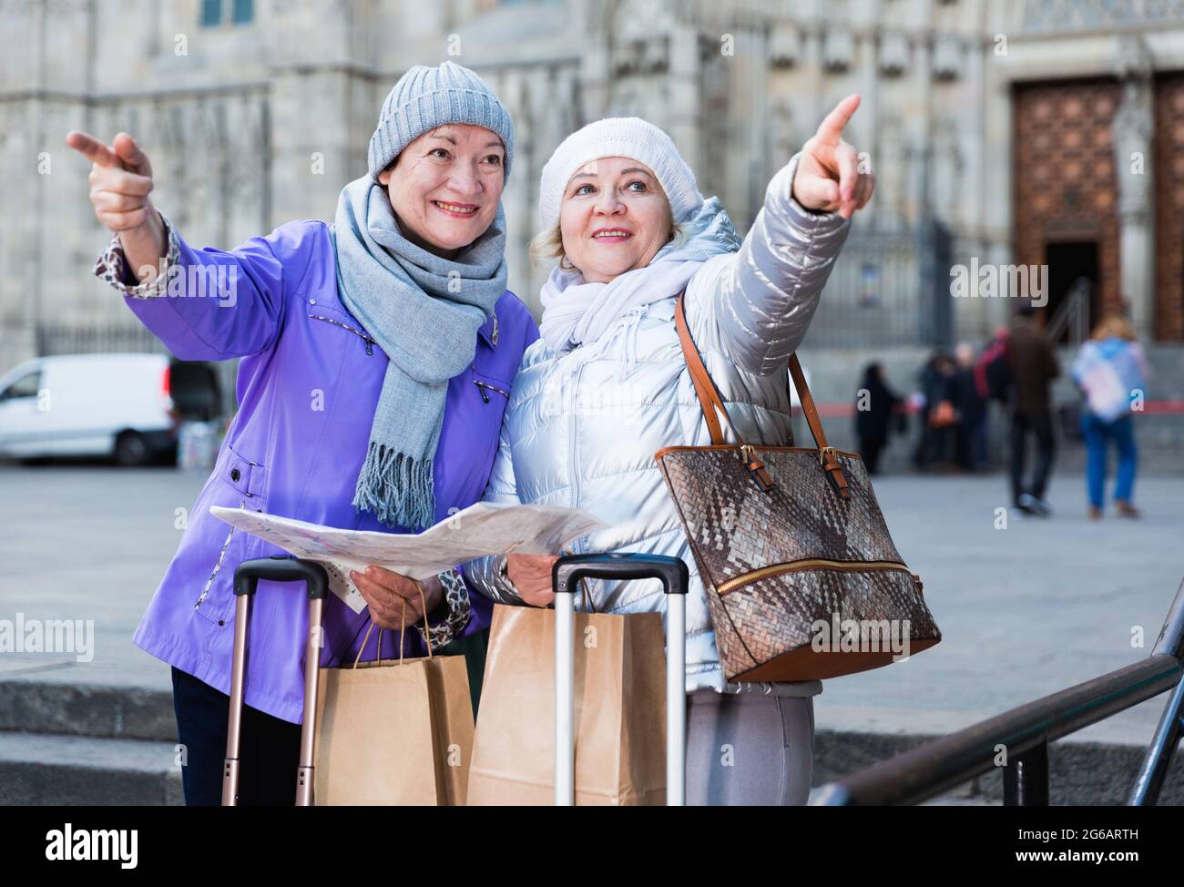 Elderly women tourists with city guide Stock Photo - Alamy