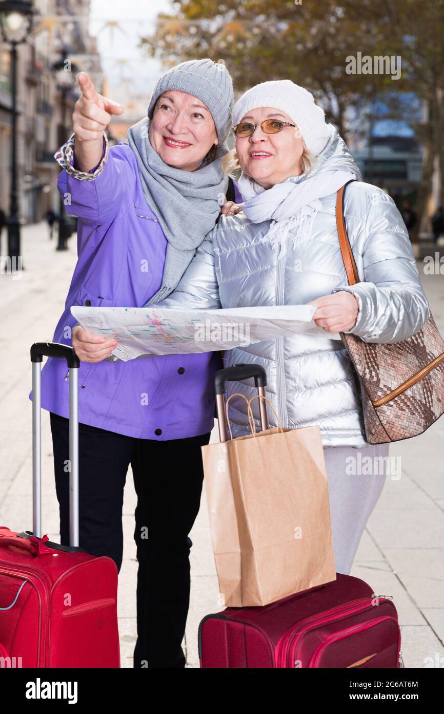Elderly women tourists with city guide Stock Photo - Alamy