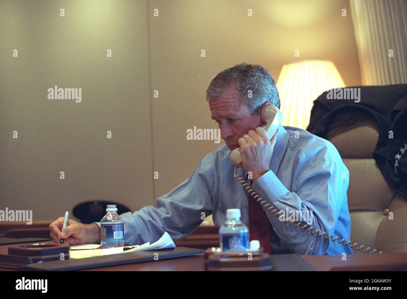 President George W. Bush confers with staff via telephone Tuesday, Sept ...