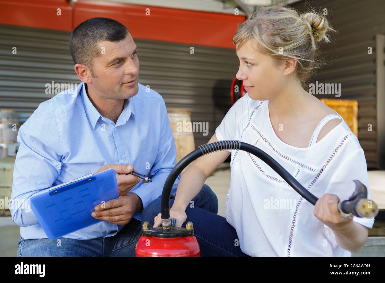 checking a fire extinguisher using clipboard Stock Photo - Alamy