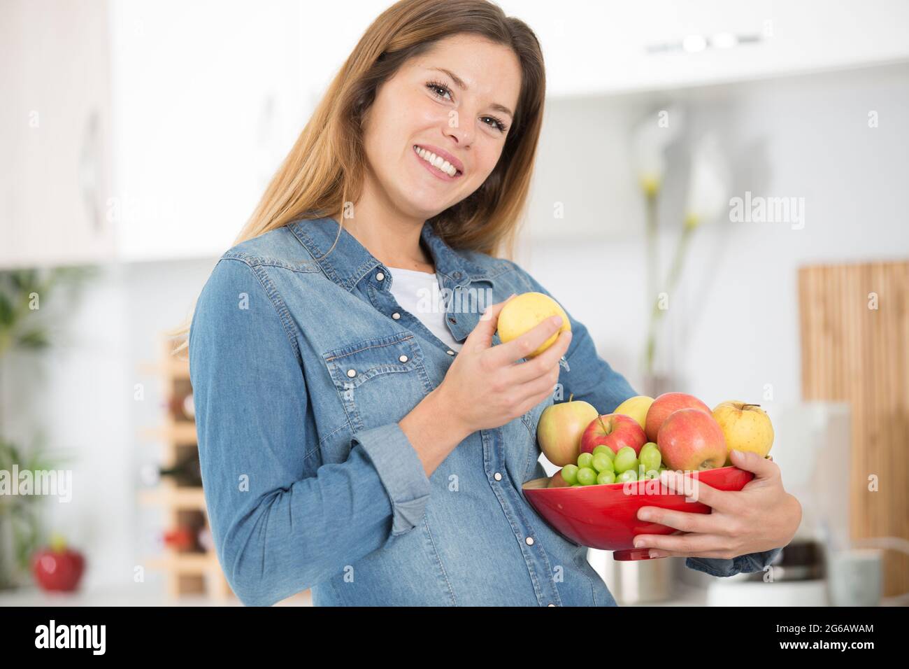 Blond woman eating banana hi-res stock photography and images - Alamy