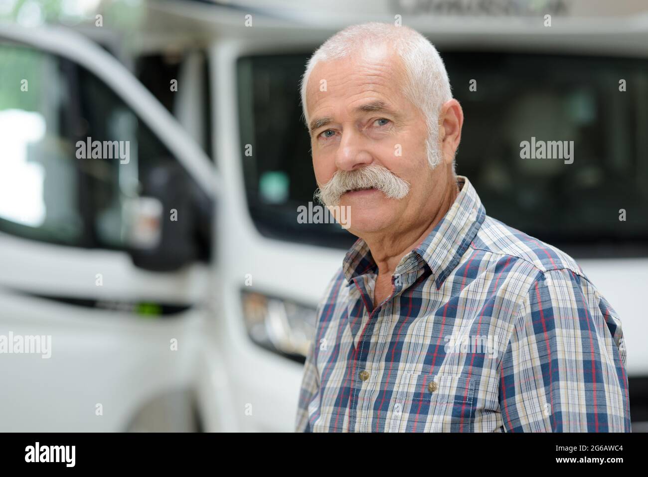 senior driver with truck in background Stock Photo - Alamy
