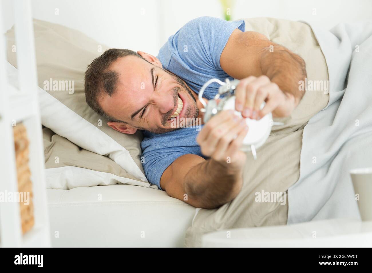 angry man wants to break an alarm with Stock Photo - Alamy