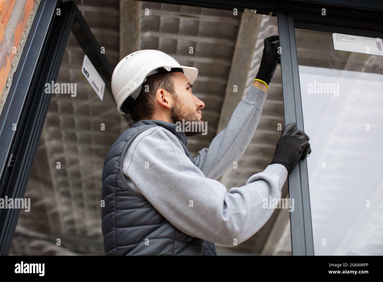 construction worker installing window in house Stock Photo - Alamy