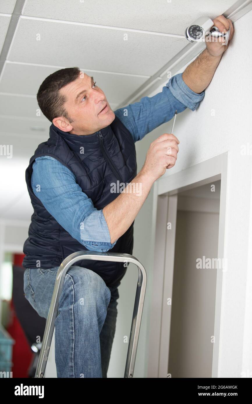 Mature service man installing hi-res stock photography and images - Alamy