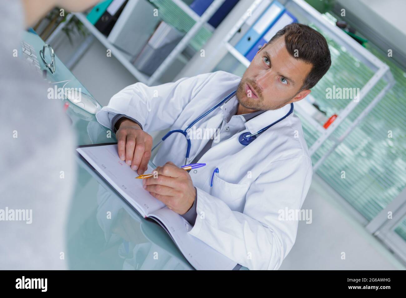 doctor with patient finding date in diary for appointment Stock Photo ...