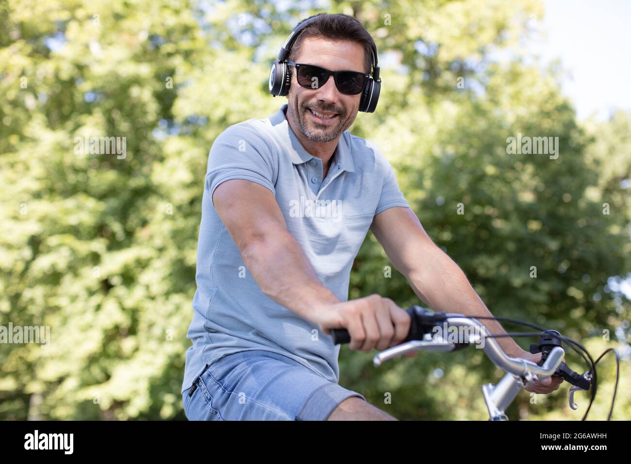 handsome man on a bike Stock Photo - Alamy
