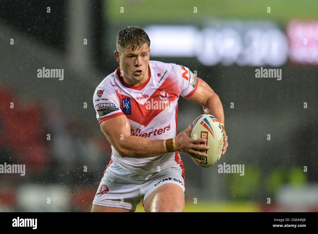Morgan Knowles (13) of St Helens runs forward with the ball Stock Photo ...