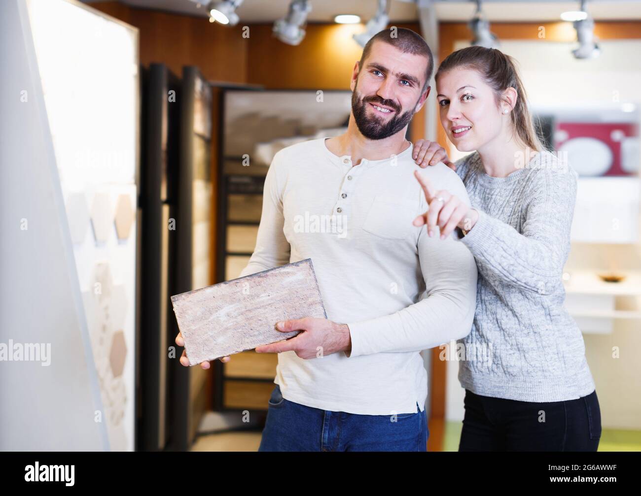 Active couple looking sample of ceramic tile Stock Photo - Alamy