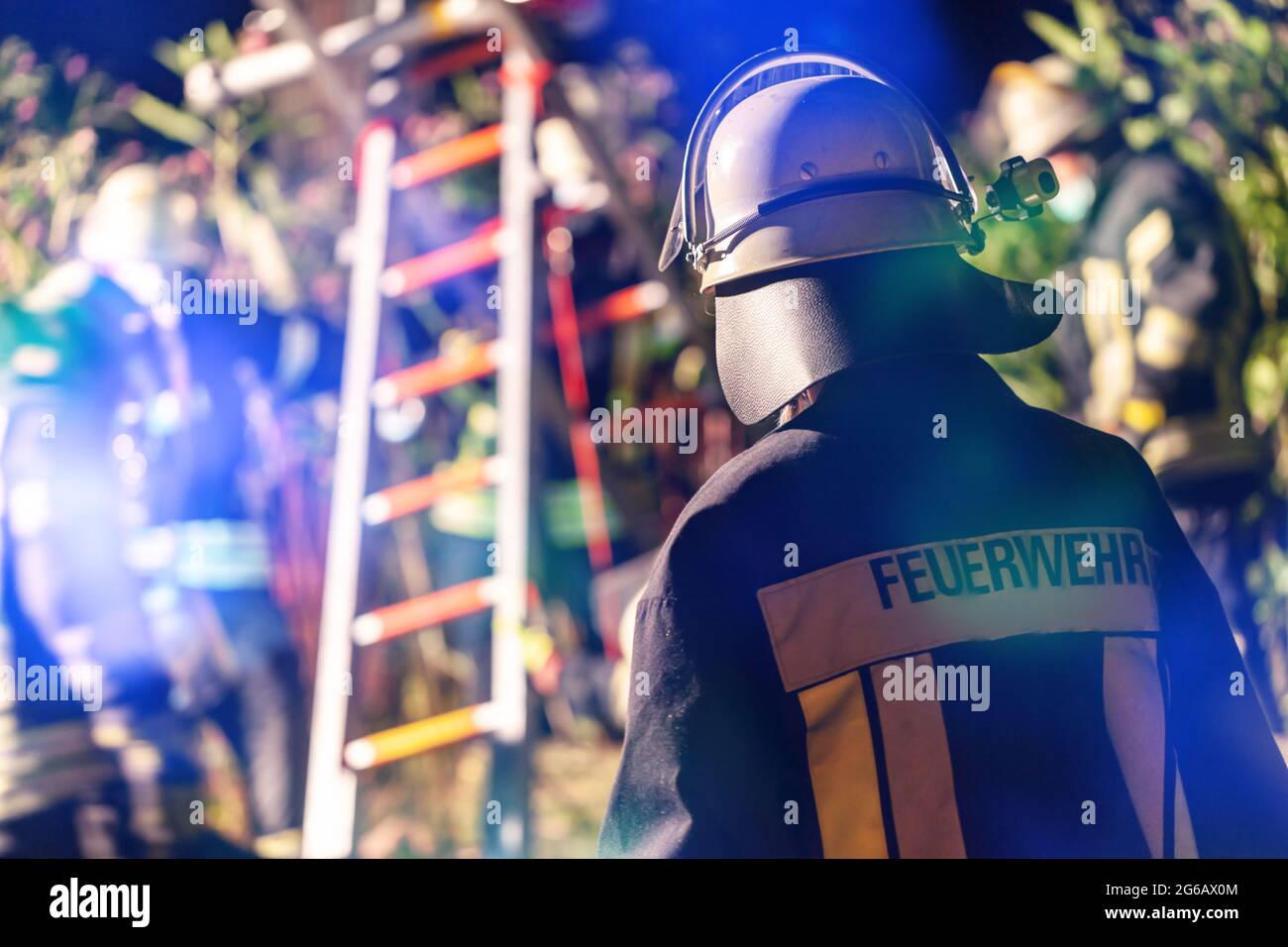 German firefighter at a rescue mission at night, training situation ...