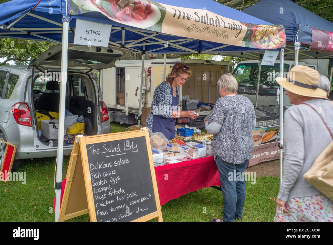 Customer queue at "The Salad Lady" stall at a Farmers market at ...