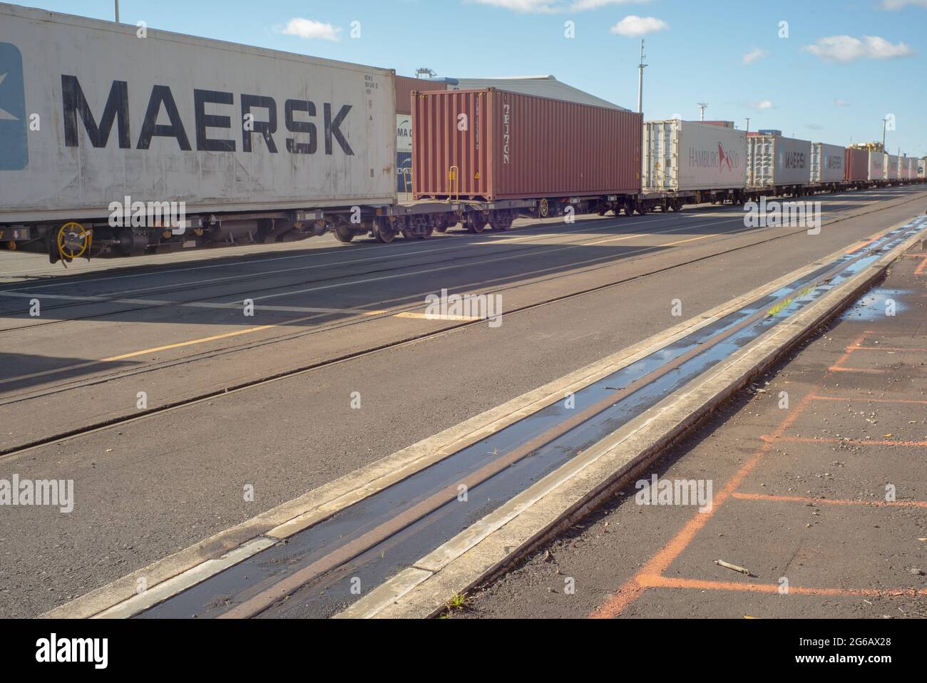 Railway wagons loaded with containers at Ports of Auckland Stock Photo ...