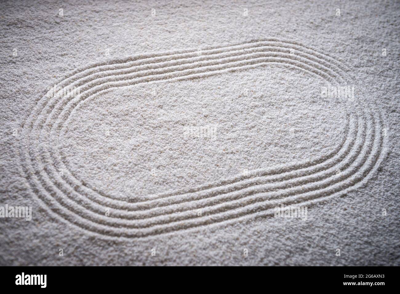 Japanese Zen garden raked with a simple sports running track oval in ...