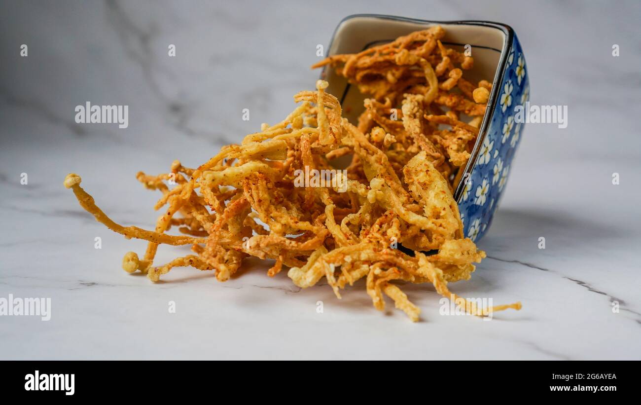 Crunchy deep fried Enoki Mushrooms with chilli flakes. Delicious snacks ...